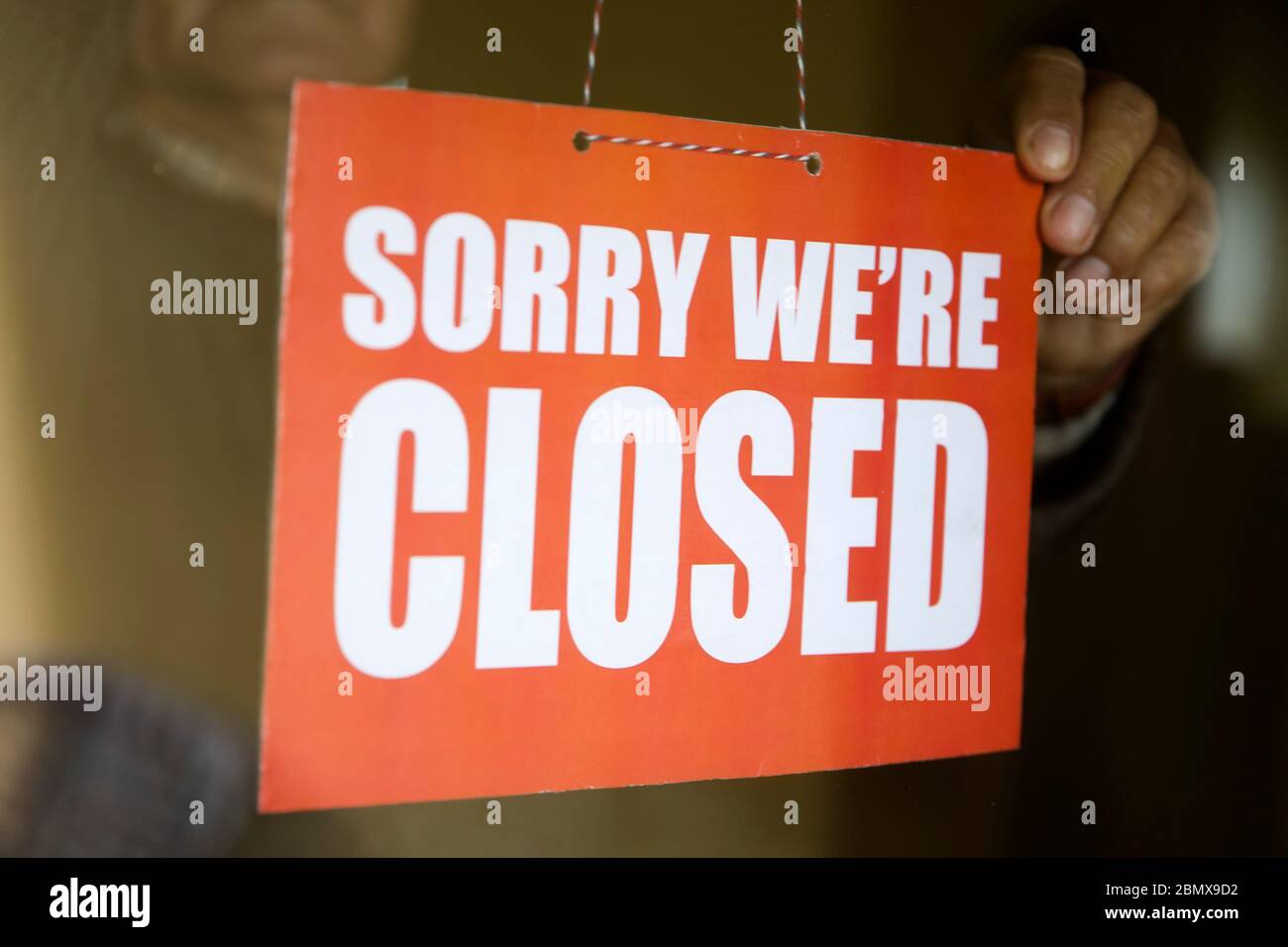 Business store owner turning closed sign at glass shop doorway Stock ...