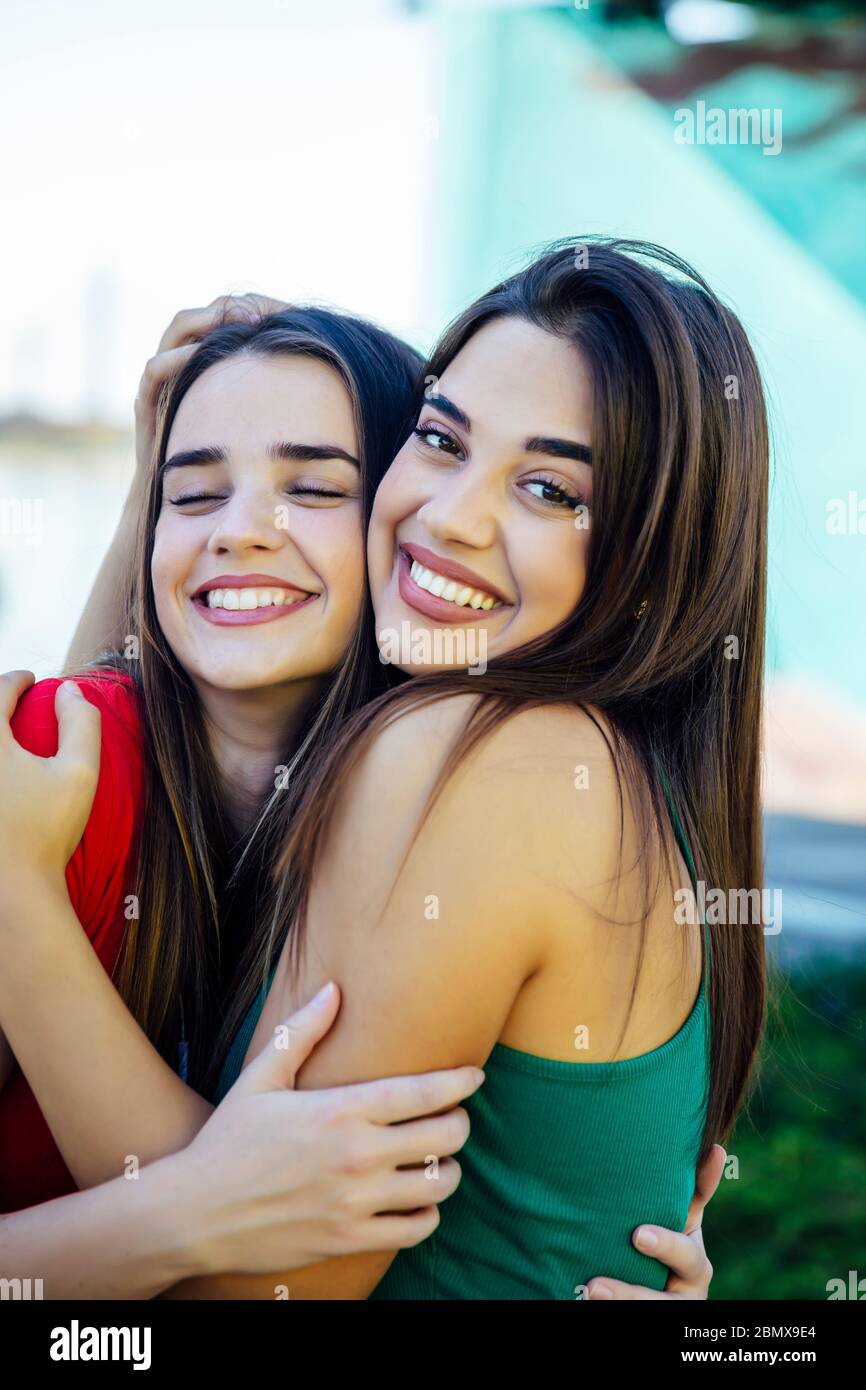 Two best female friends embracing together outdoors Stock Photo - Alamy