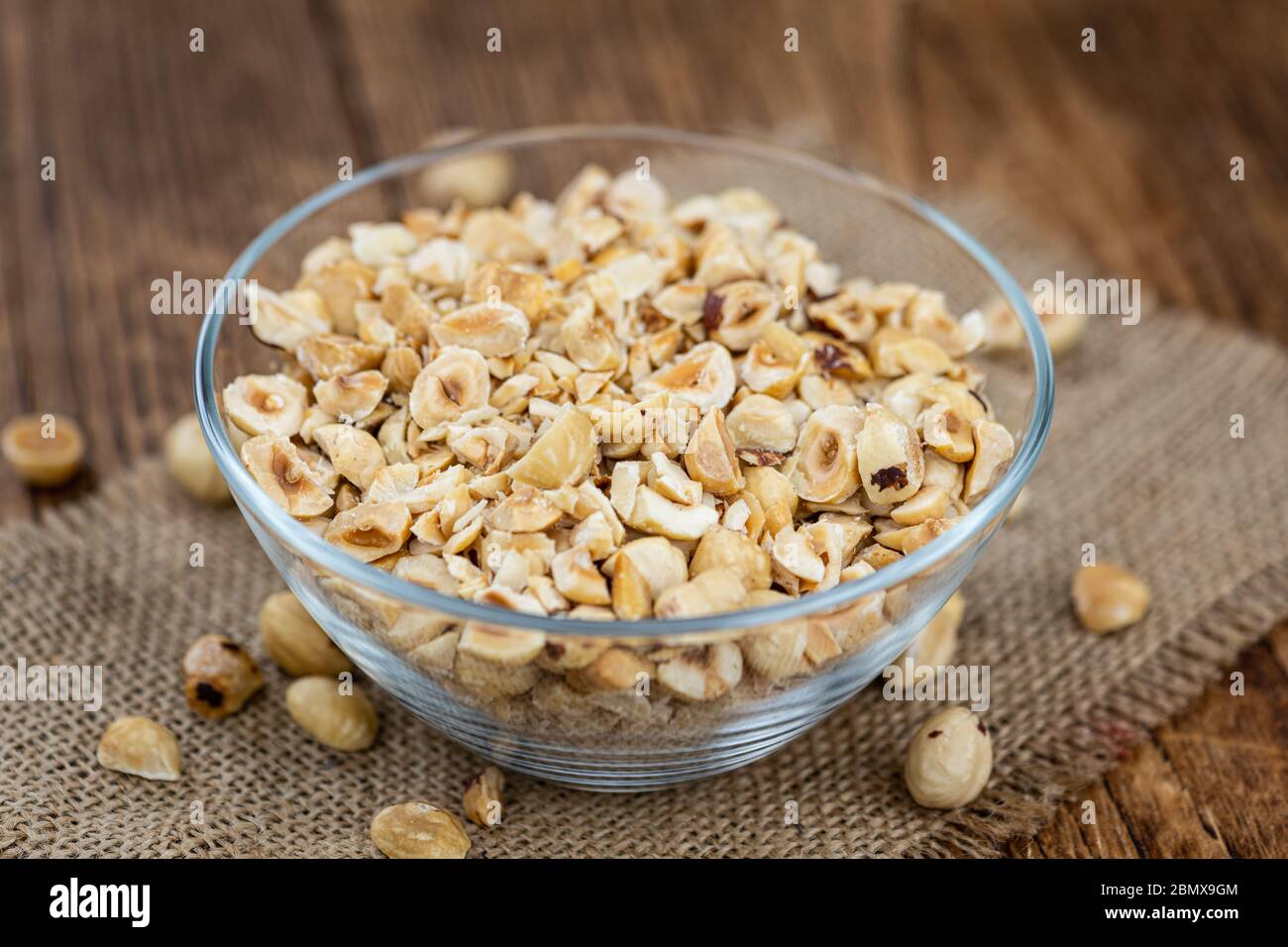 Freshly chopped Hazelnuts as detailed close up shot (selective focus ...