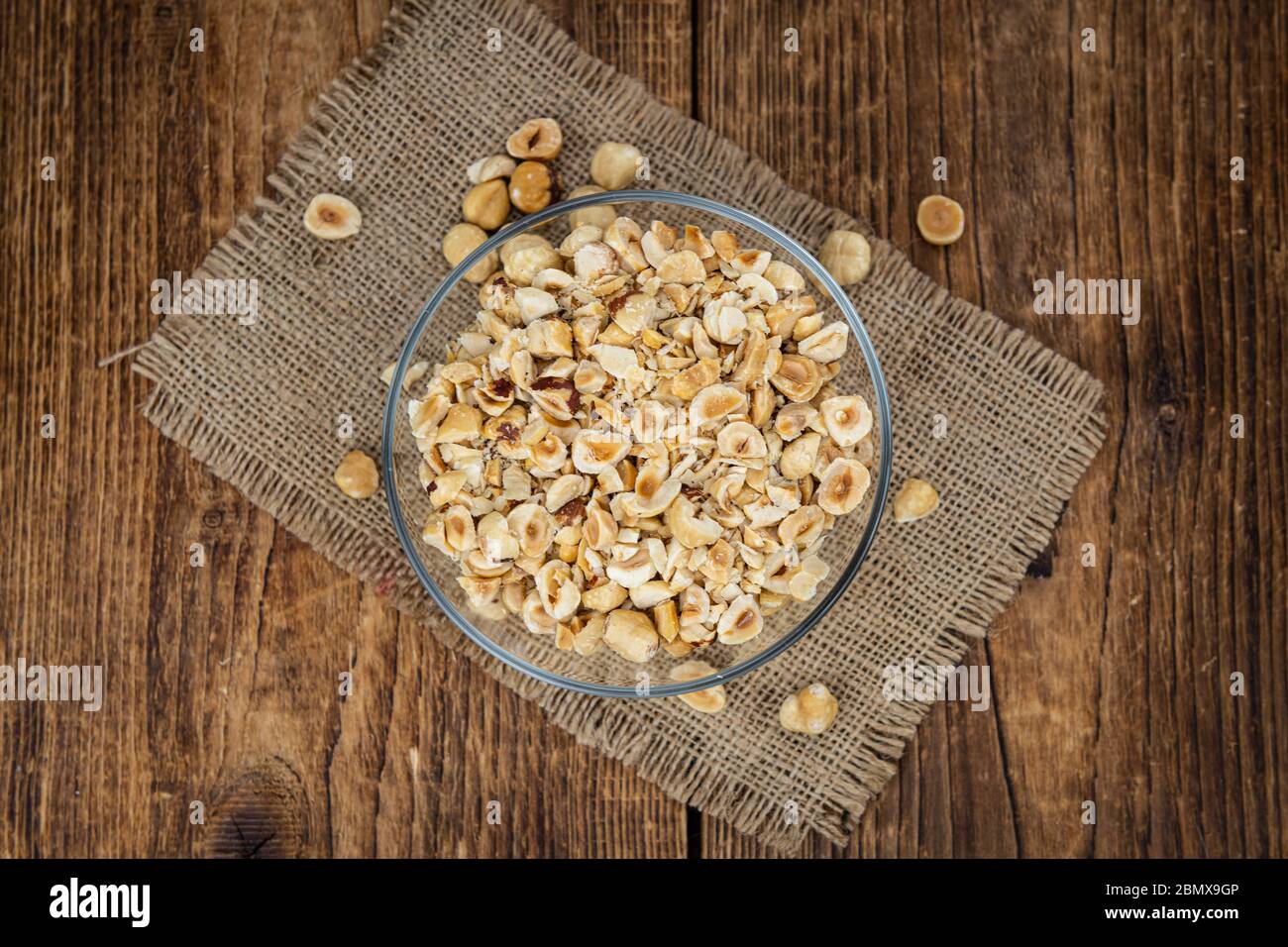 Portion of freshly chopped Hazelnuts on an old wooden table as detailed ...