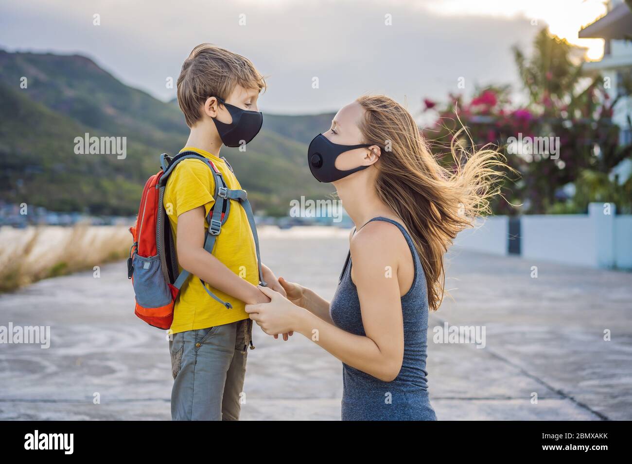 Mother puts her child a face protective mask on the street. Stop the ...