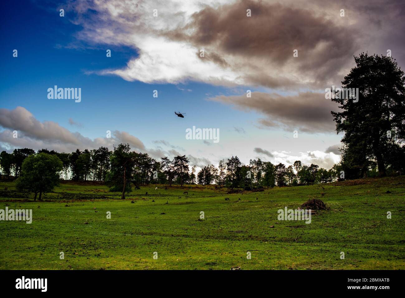 A RAF helicopter fly over the new forest as a storm moves in ...