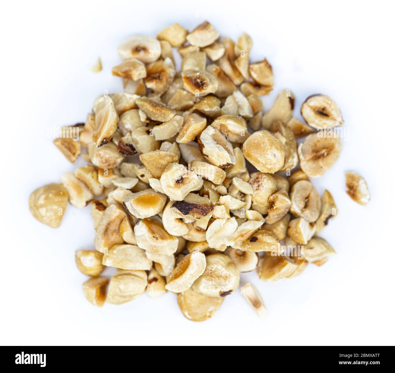 Freshly chopped Hazelnuts as detailed close up shot isolated on white ...
