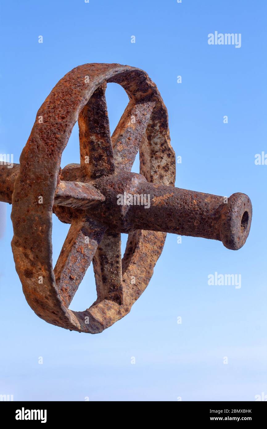 A rusty iron hub with a wheel from a vintage retro wagon. Old piece of ...