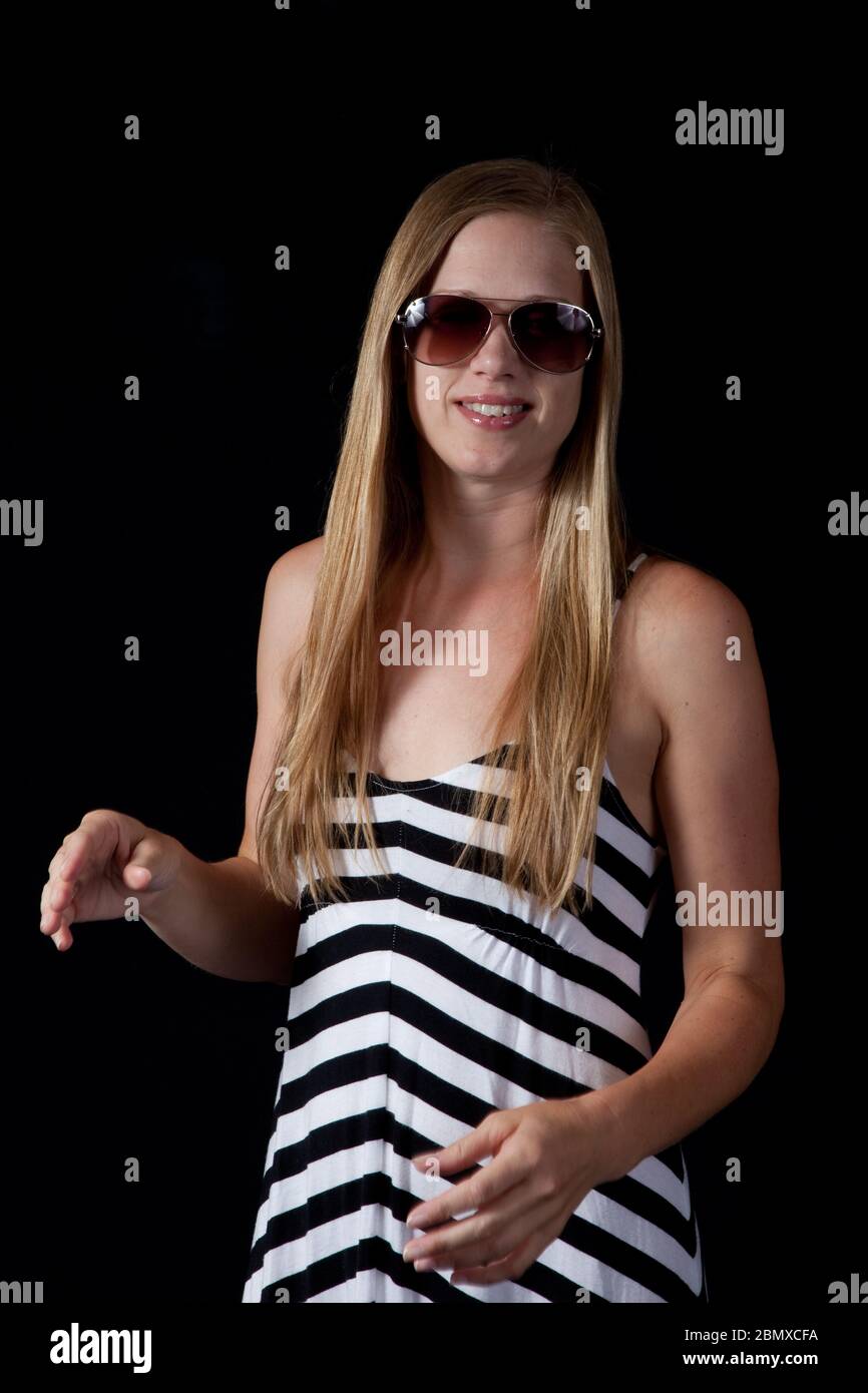 Blond woman in stripped dress and sunglasses Stock Photo - Alamy