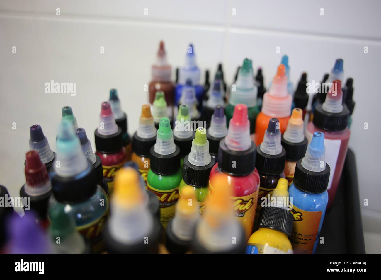A selection of various colours of ink / dye in a tattoo artist's studio ...