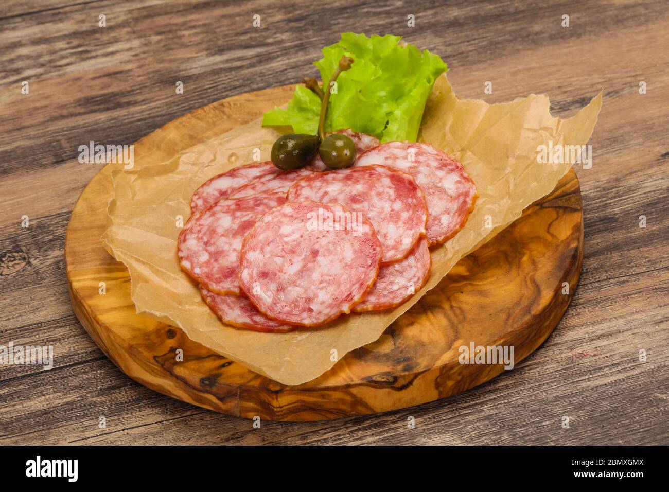 Spanish Salchichon sausage with salad leaves Stock Photo - Alamy