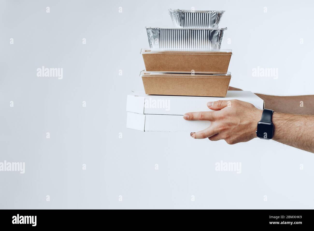 Courier hands giving packed food delivery close up Stock Photo - Alamy