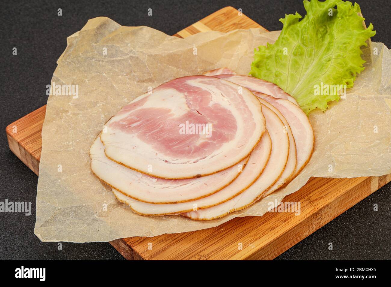 Sliced Italian Pancetta sausage over board Stock Photo - Alamy