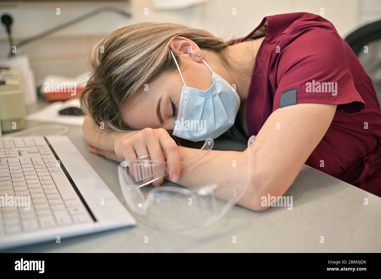 Young Doctor Sleeping On The Desk In Medical Office Stock Photo - Alamy
