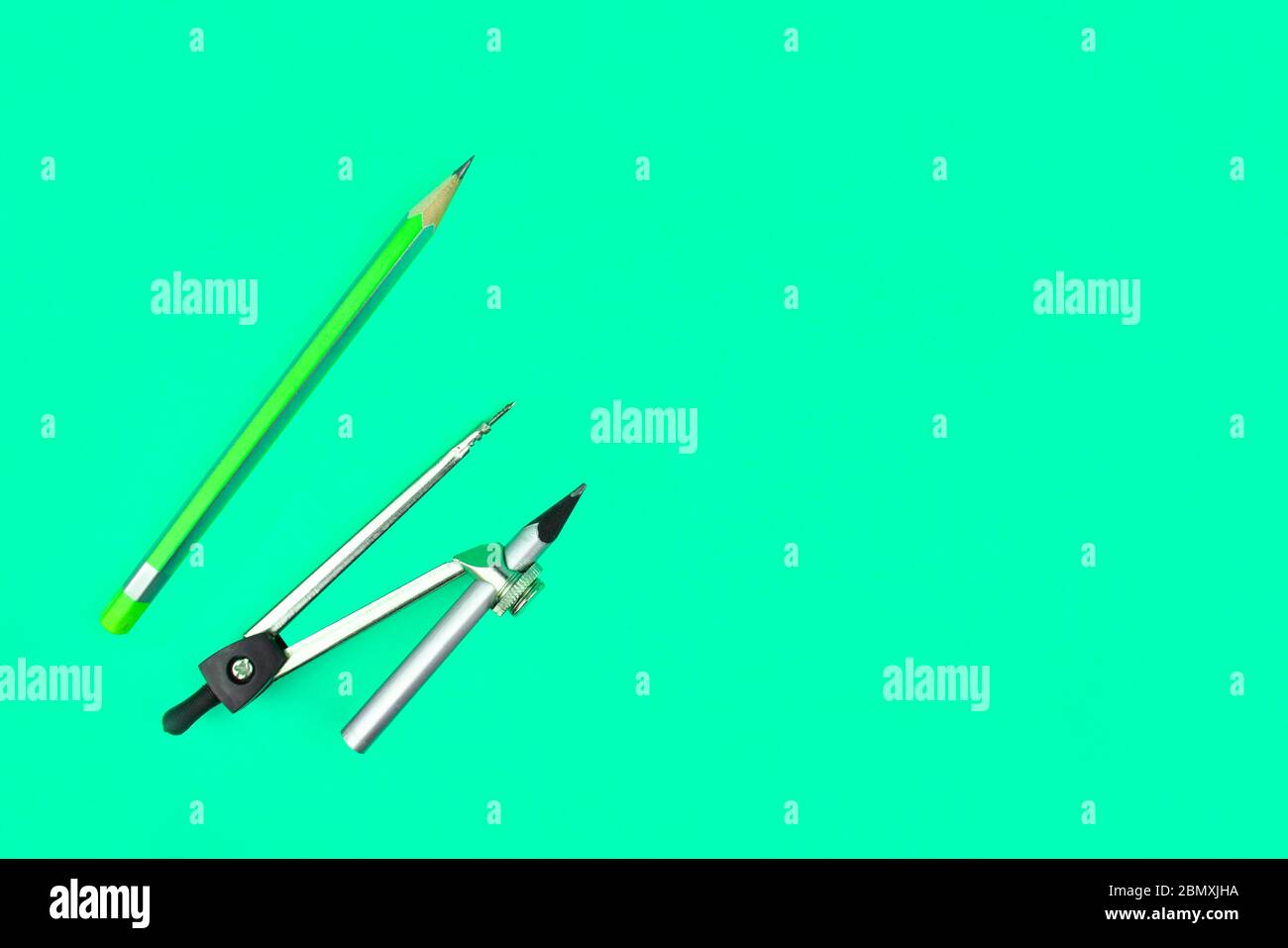 Green pencil and a silver color wood pencil attached to a pencil ...