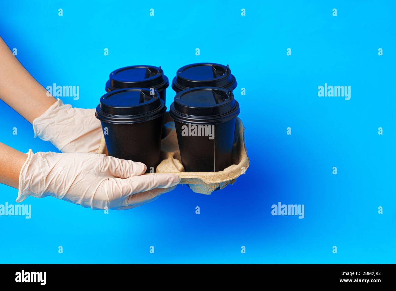 Coffee delivery. Human hand holding takeaway coffee cup Stock Photo - Alamy