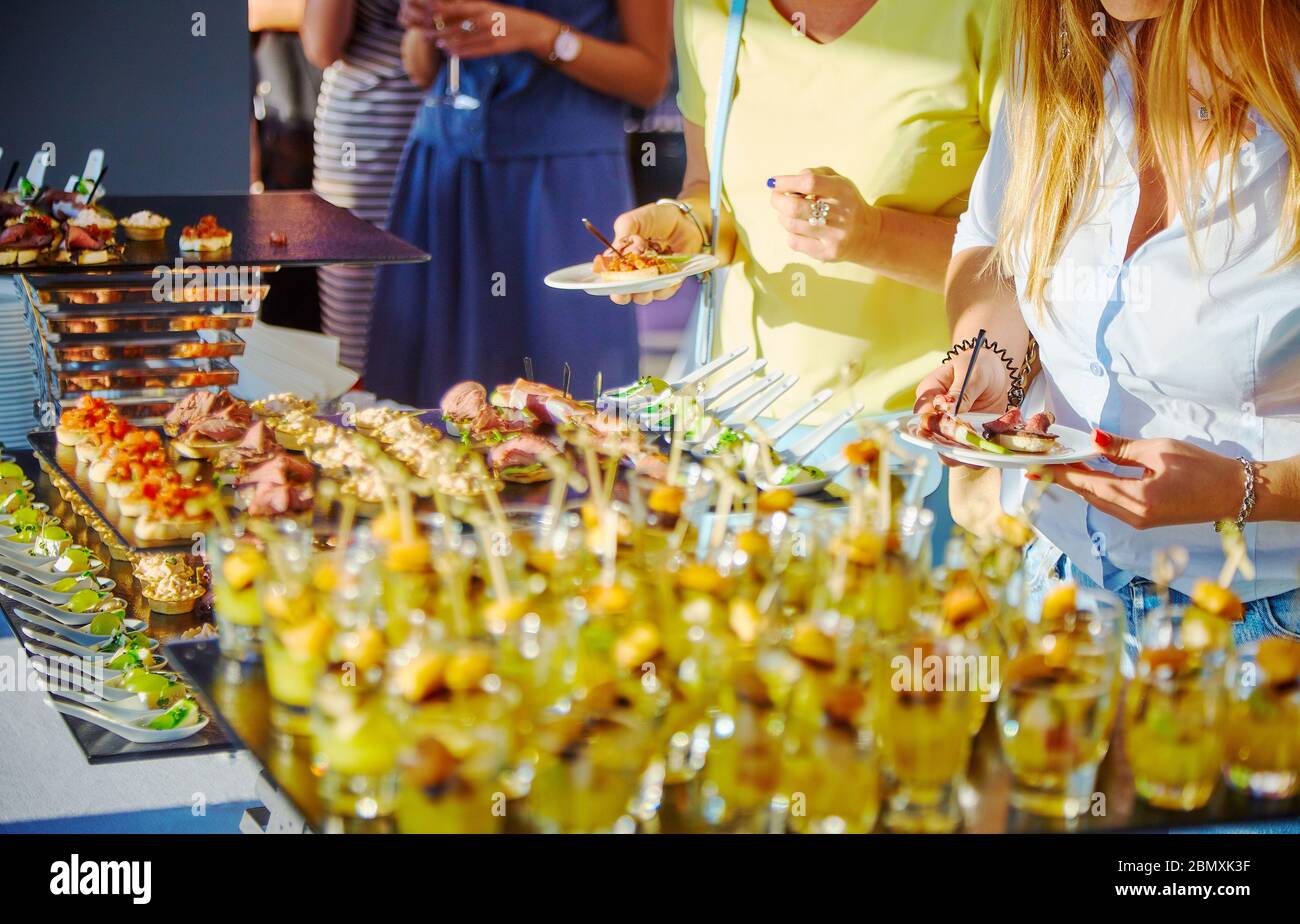Female hands taking food at a banquet at a conference Stock Photo - Alamy