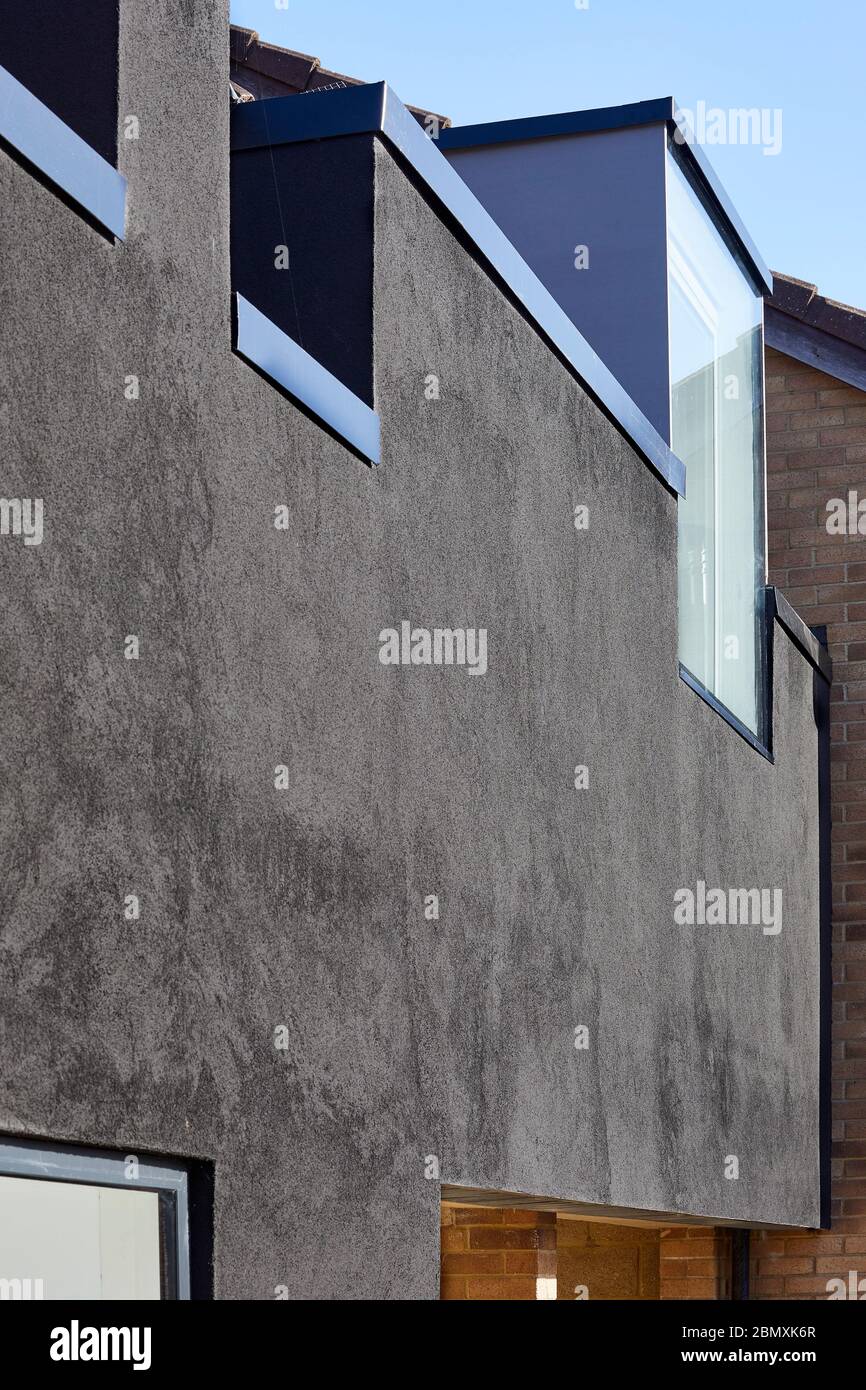 Detail of large bedroom dormer window with deep black render. Cut ...