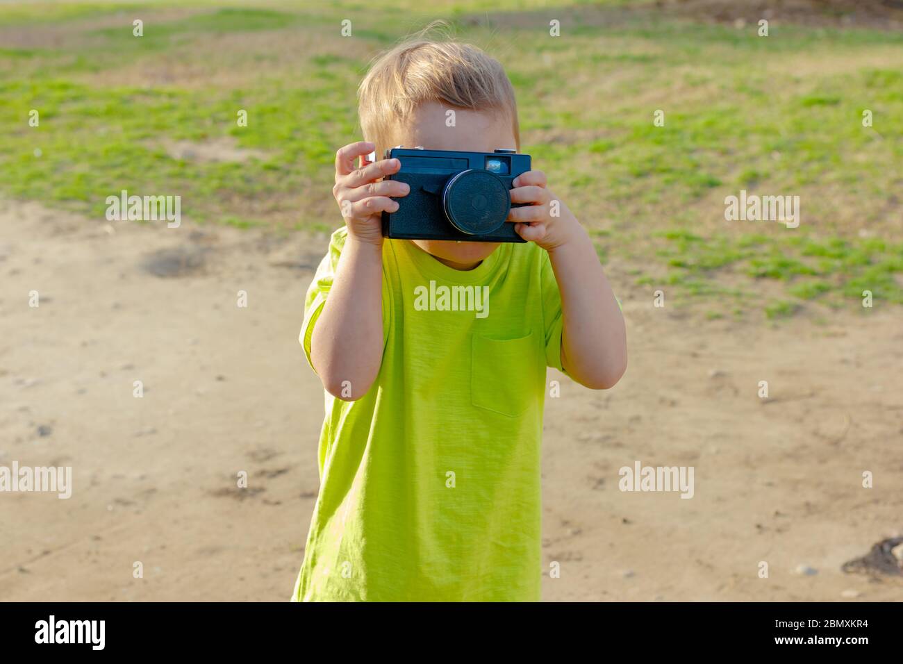Little boy using vintage camera. Cute caucasian child taking photo with ...