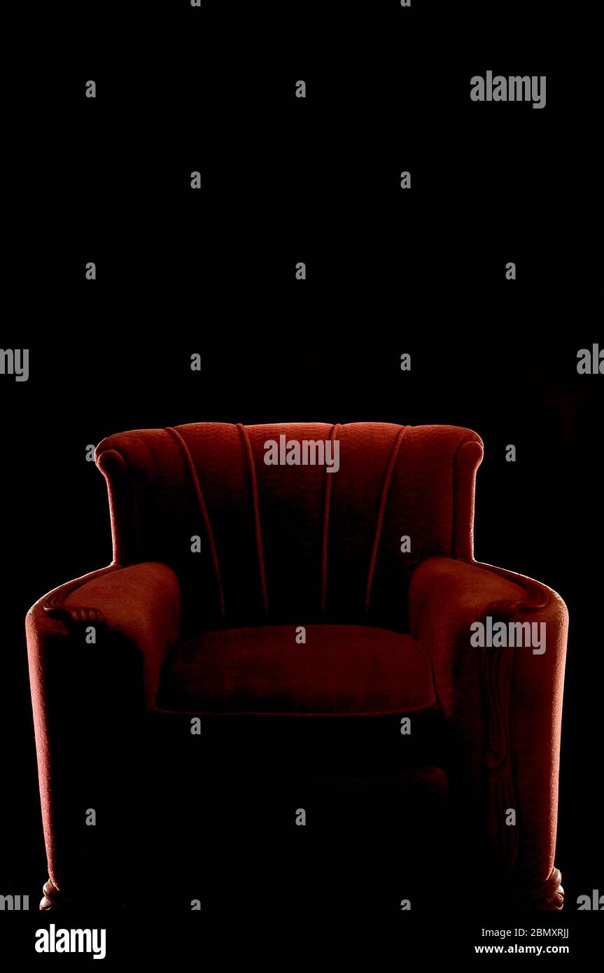 silhouette of red arm chair on black background Stock Photo - Alamy