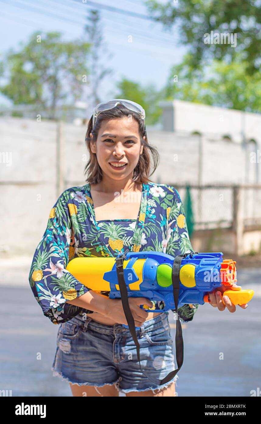 Woman holding a water gun hi-res stock photography and images - Alamy