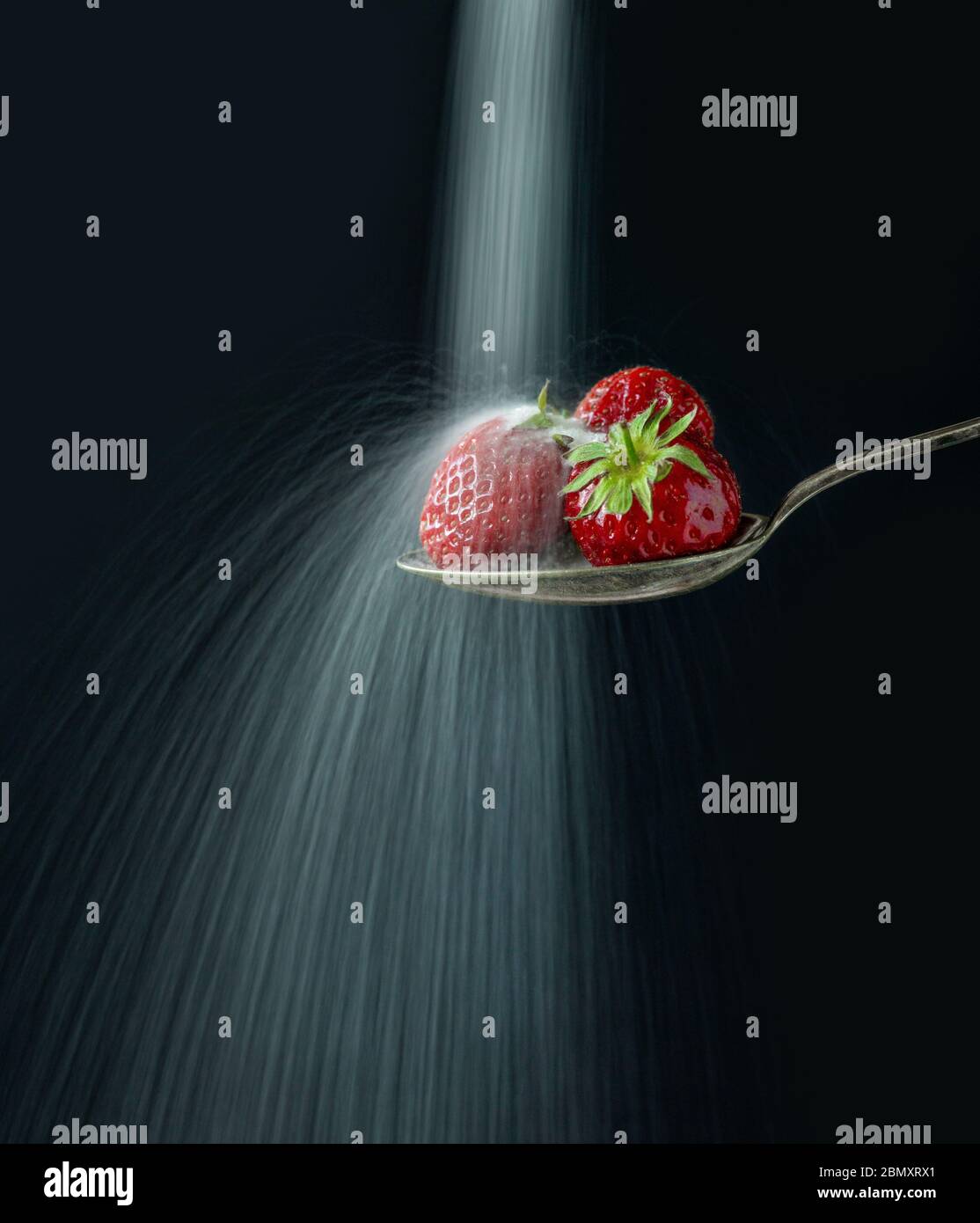 sugar falls on strawerries, selective focus, black background Stock ...