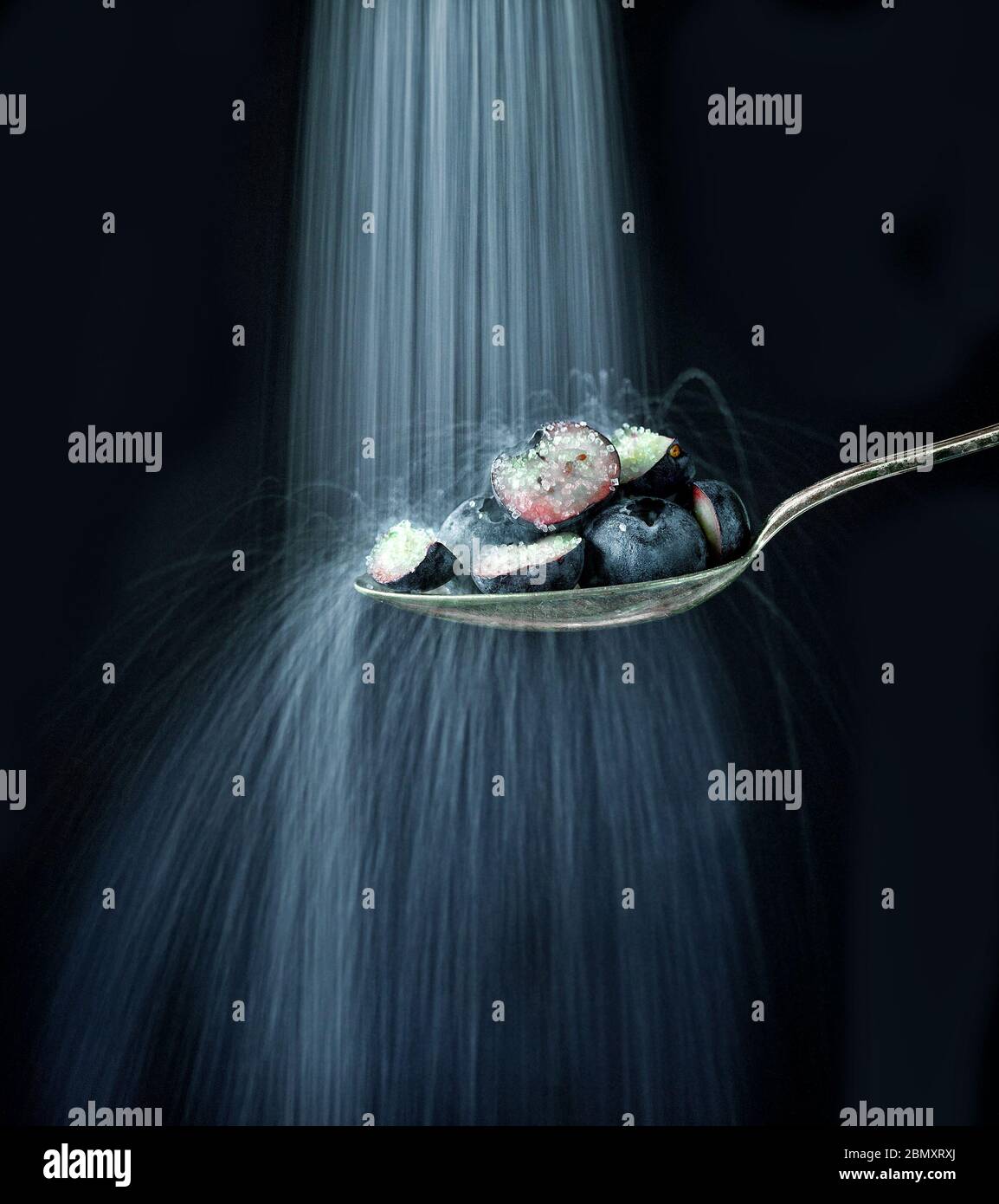 sugar falls on blueberries, selective focus, black background Stock ...