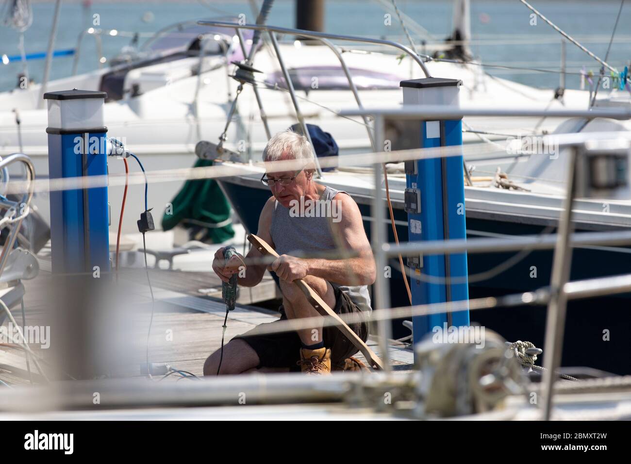 yacht owner working at UK boatyard Stock Photo - Alamy