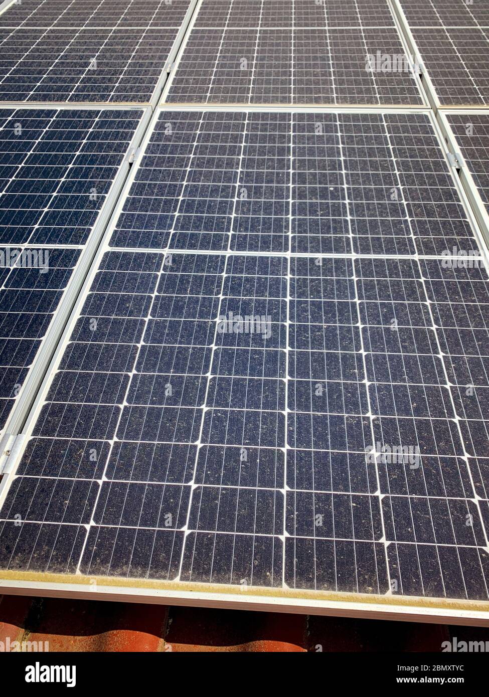 Photovoltaic solar panel installed on a roof Stock Photo - Alamy