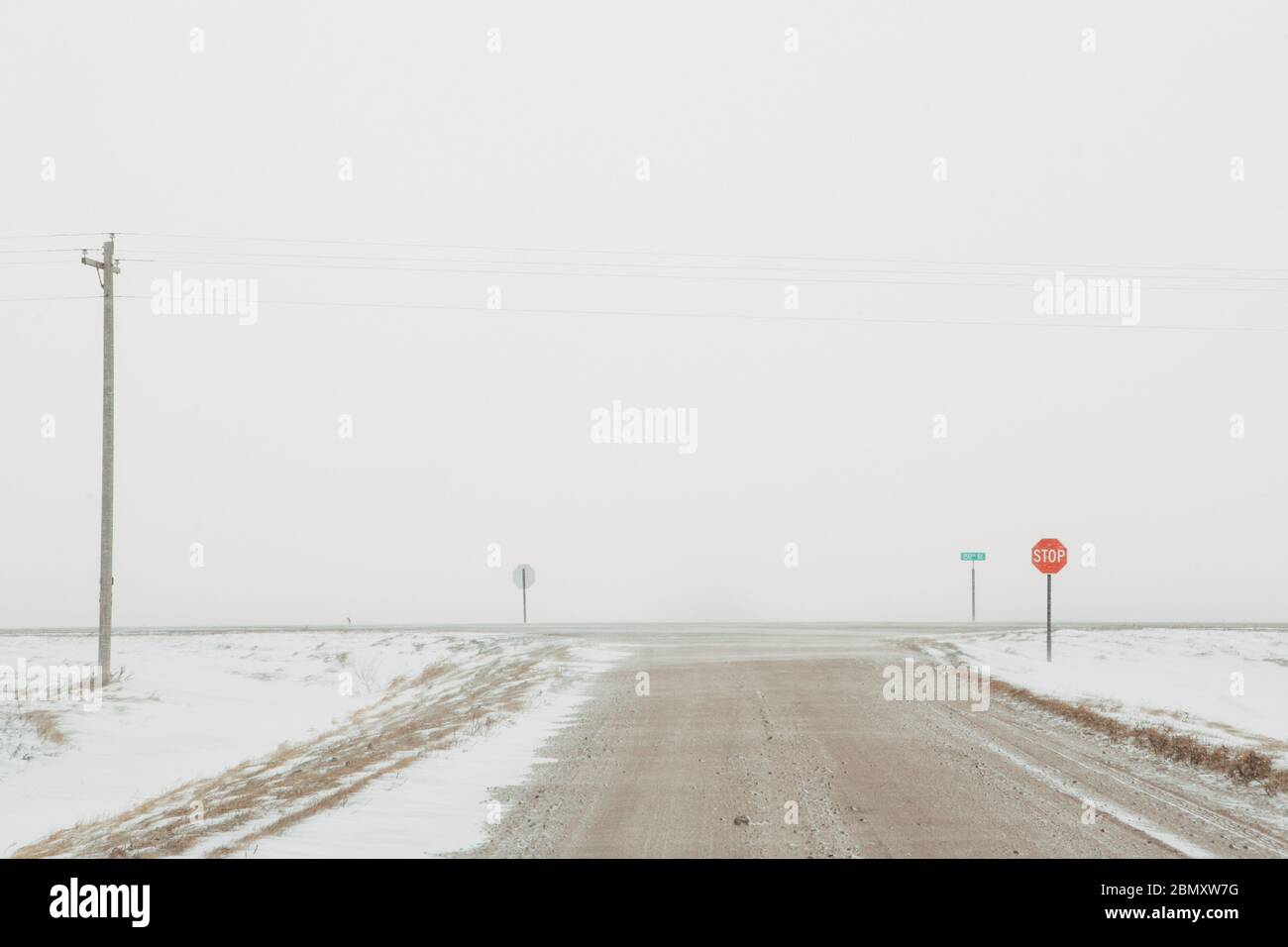 Blizzard conditions rural highway intersection Stock Photo - Alamy