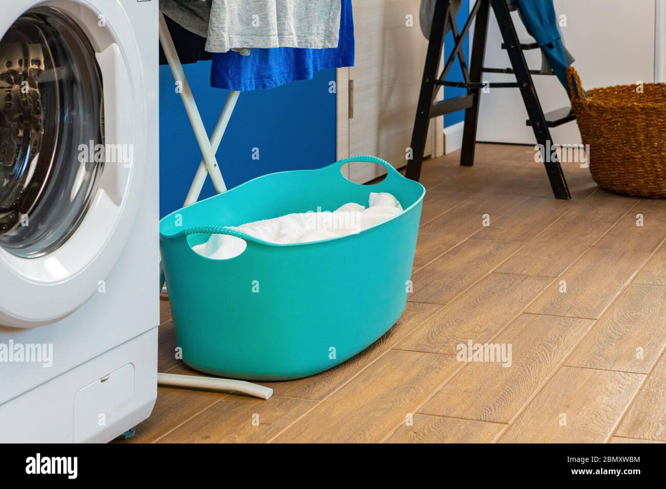Laundry room interior with washing machine and clothes dryer near wall ...