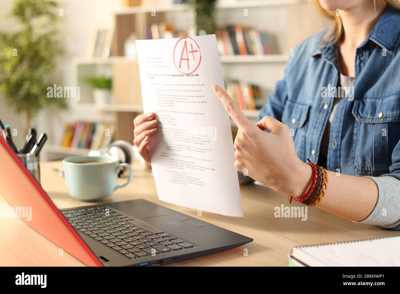 Close up of student girl hands showing passed exam on video call on a ...