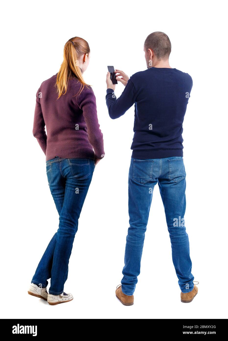 Back view of couple in sweater with mobile phone. beautiful friendly ...
