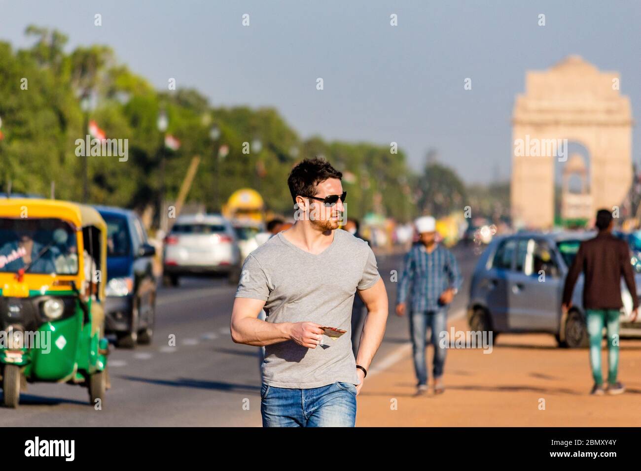 A foreign tourist enjoying his walk on the Rajpath road with the most ...