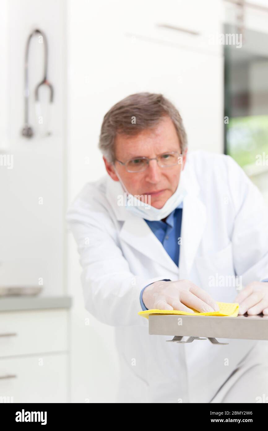 Doctor cleaning his surgery - selective focus on the hand Stock Photo ...
