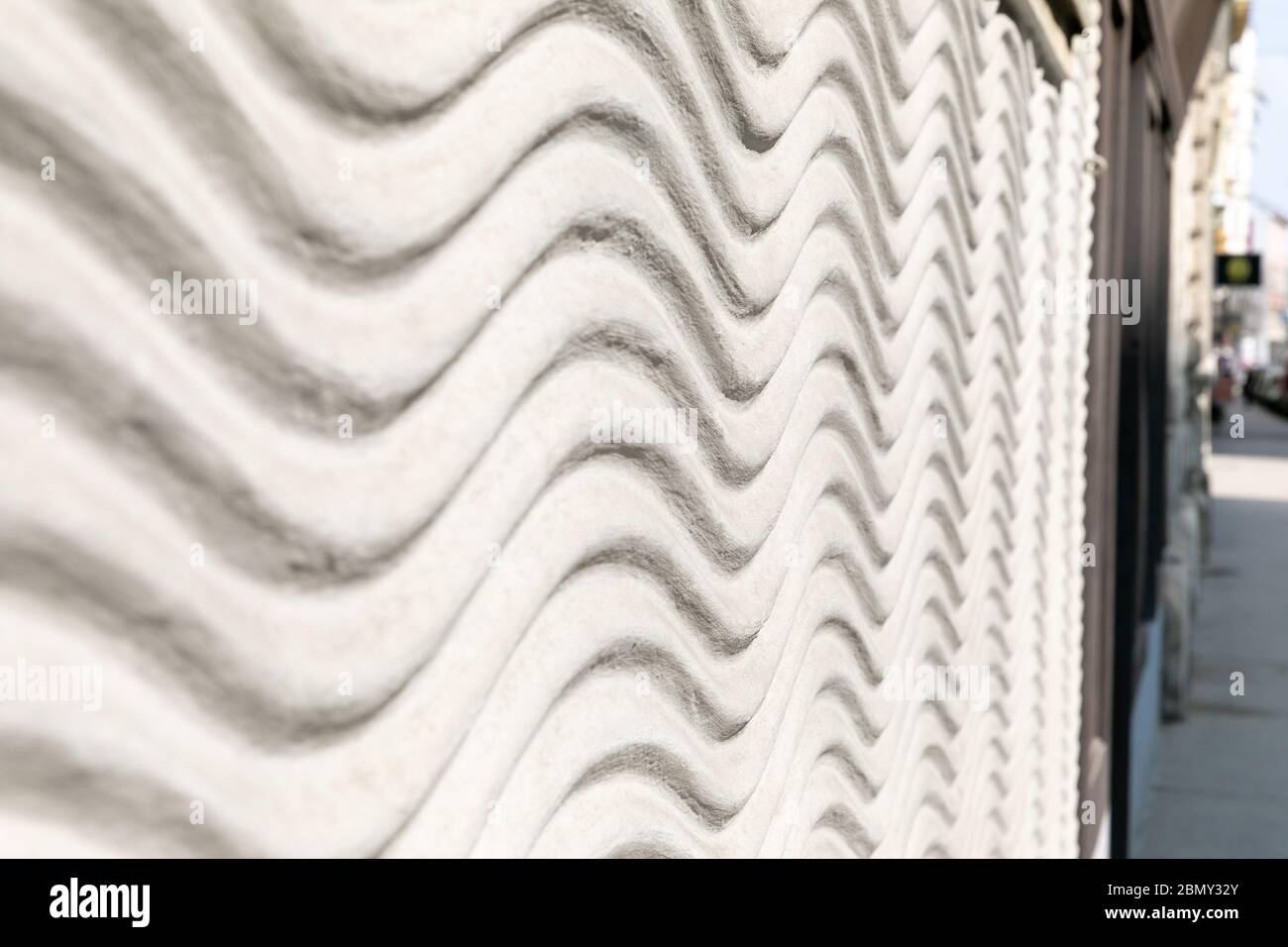 close up of a art deco relief on a house facade in the shape of waves ...