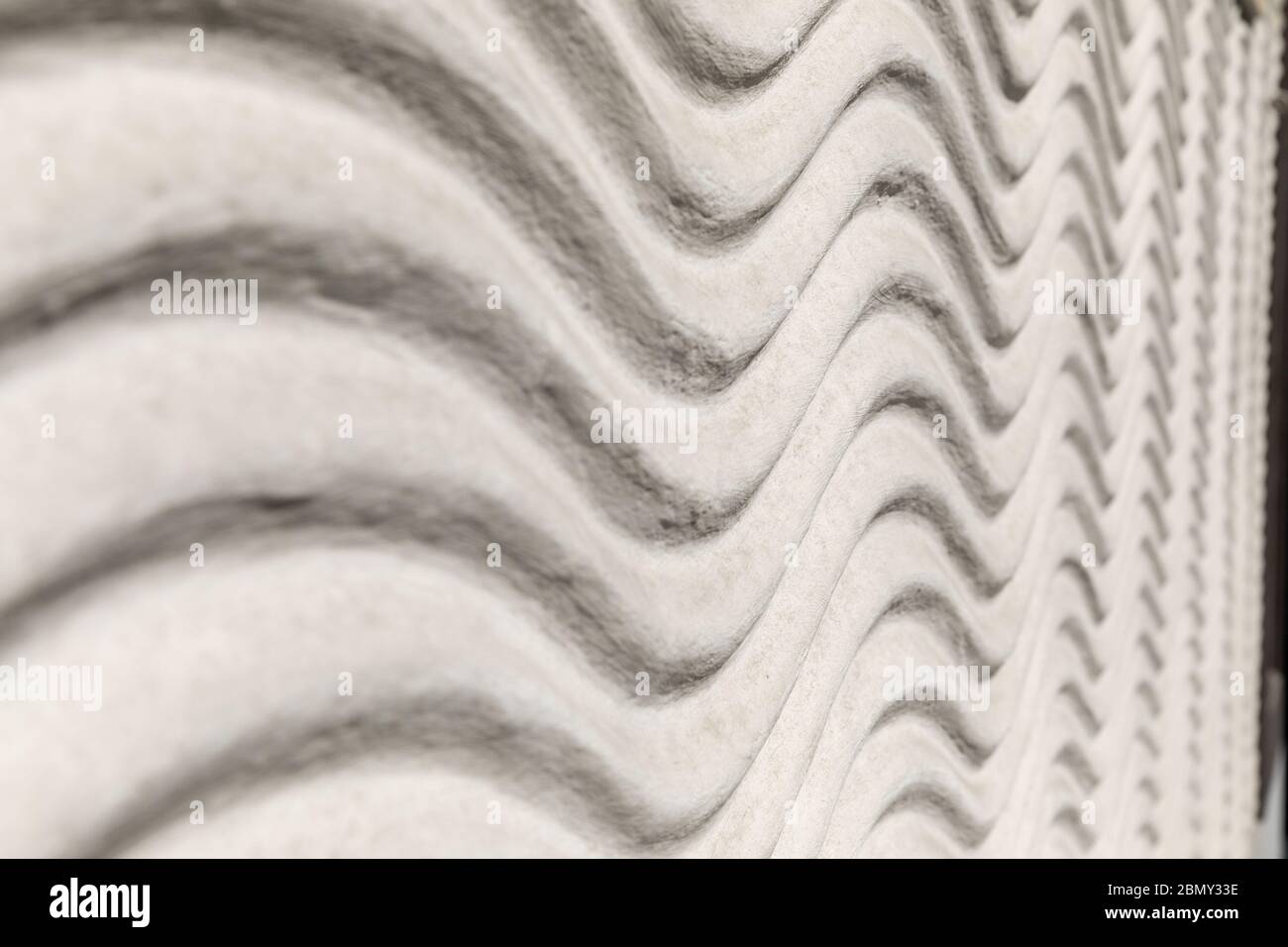 close up of a art deco relief on a house facade in the shape of waves ...