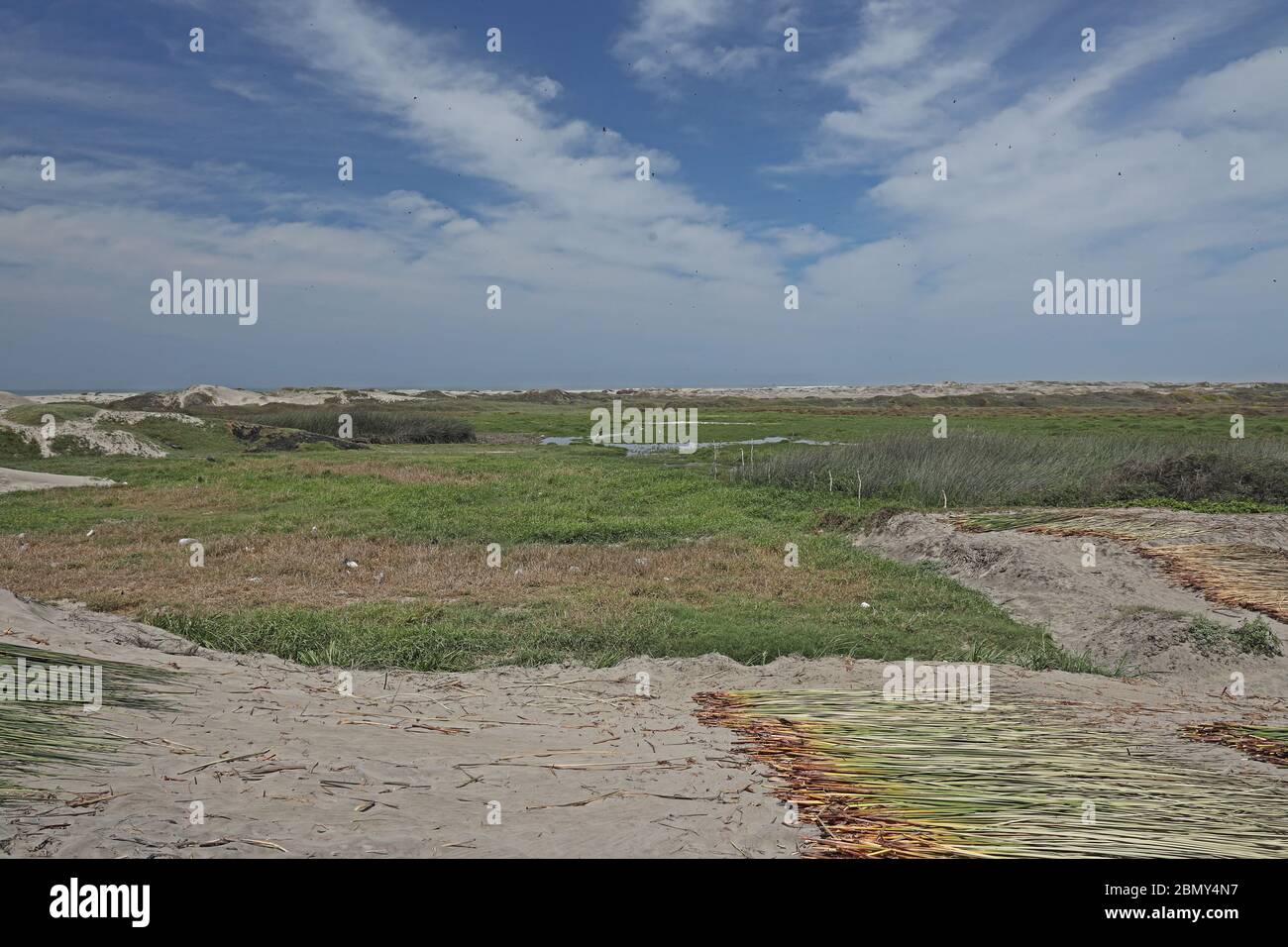 cloud formations over coastal marsh and sand dunes northern Peru ...