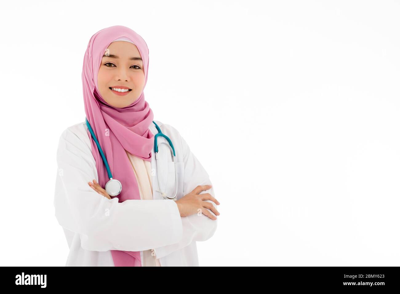 Portrait of Muslim woman doctor in hijab crossing arms with a beautiful ...