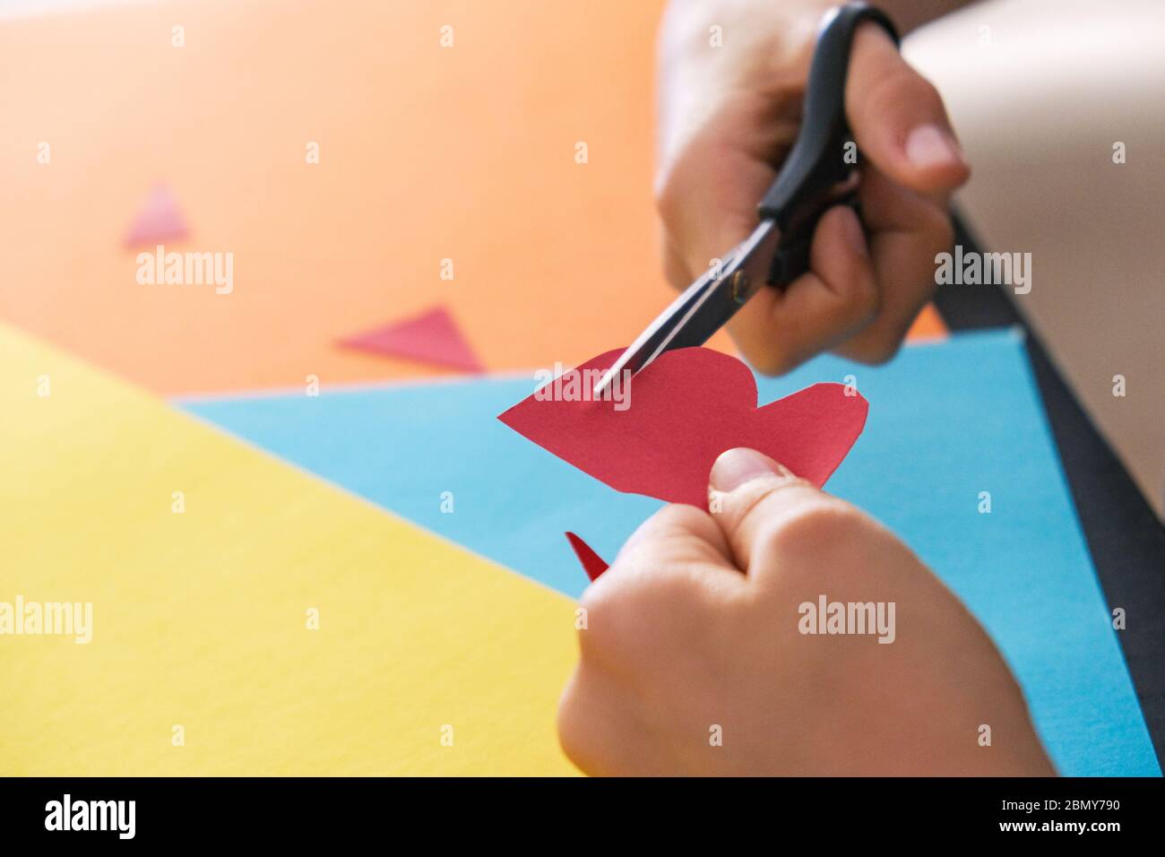 Paper crafts for kids. Child hands cutting colored paper with scissors ...