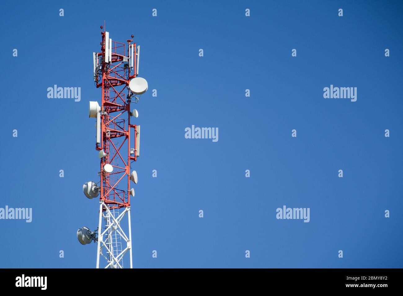 Base Station Telecommunication tower. Wireless Communication Antenna Transmitter on blue ...