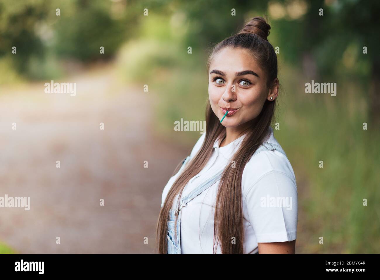 Girl with a silly facial expression, in nature Stock Photo - Alamy