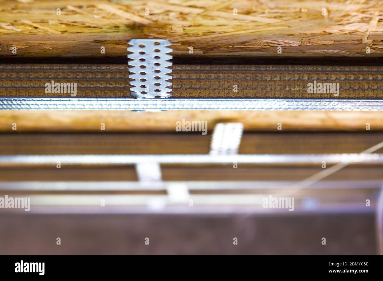 Drywall mounting profile on chipboard plate. Unfinished ceiling ...