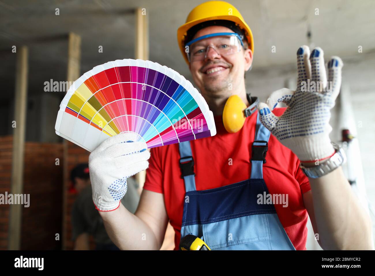 Builder helmet shows color samples to choose from Stock Photo - Alamy