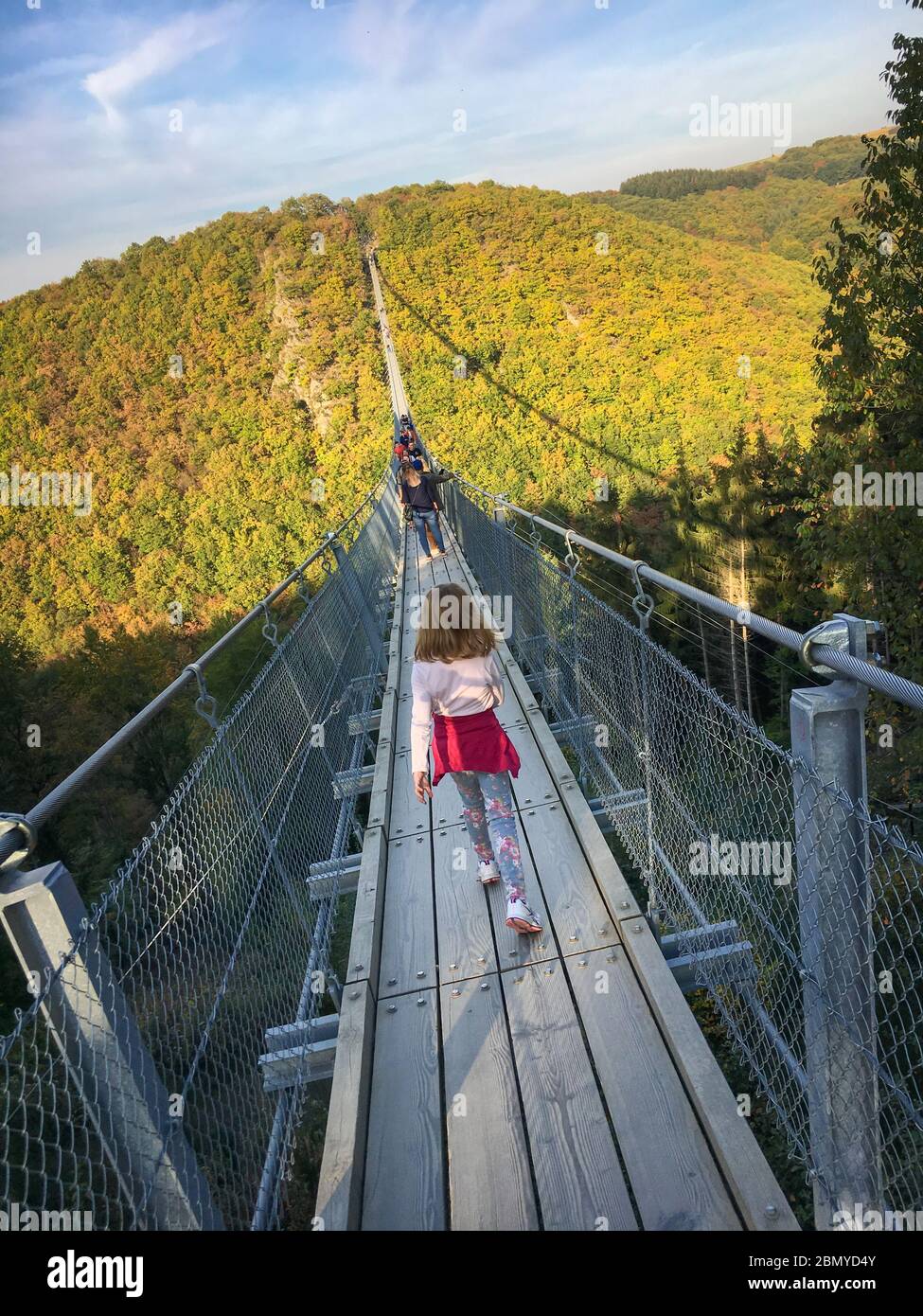 Visitors walking across Geierlay suspension bridge in the German region ...