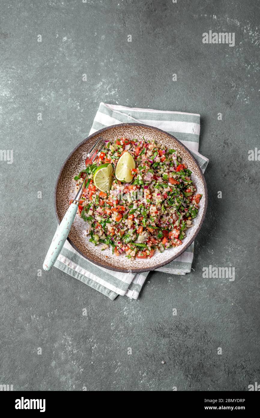 Traditional Lebanese salad tabouli tabule with quinoa, herbs, tomatoes ...