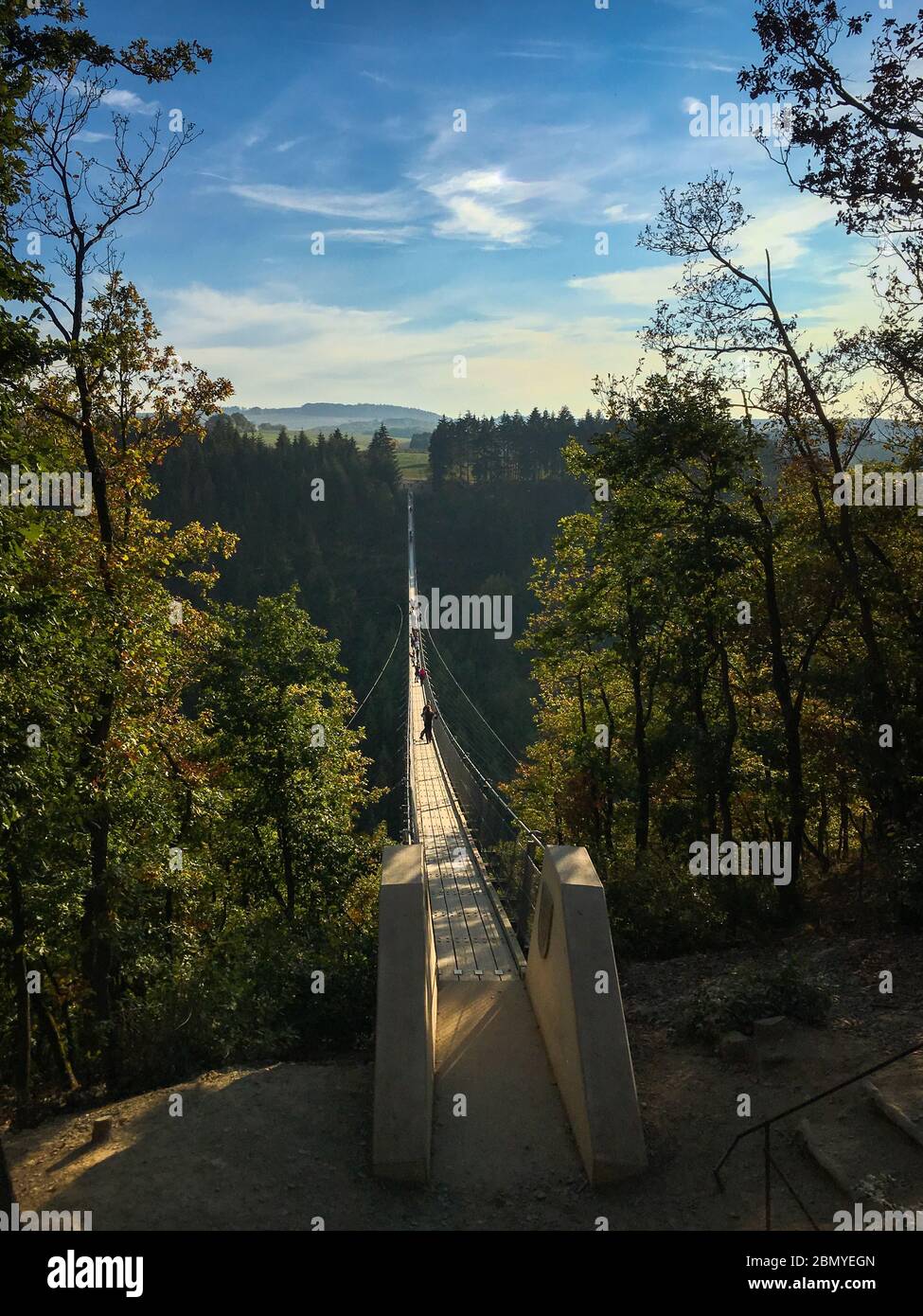 Visitors walking across Geierlay suspension bridge in the German region ...