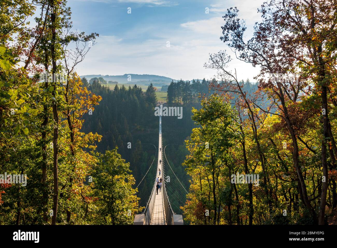Visitors walking across Geierlay suspension bridge in the German region ...
