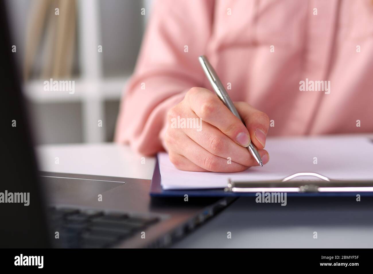 Closeup, female hands taking notes with pen office Stock Photo - Alamy