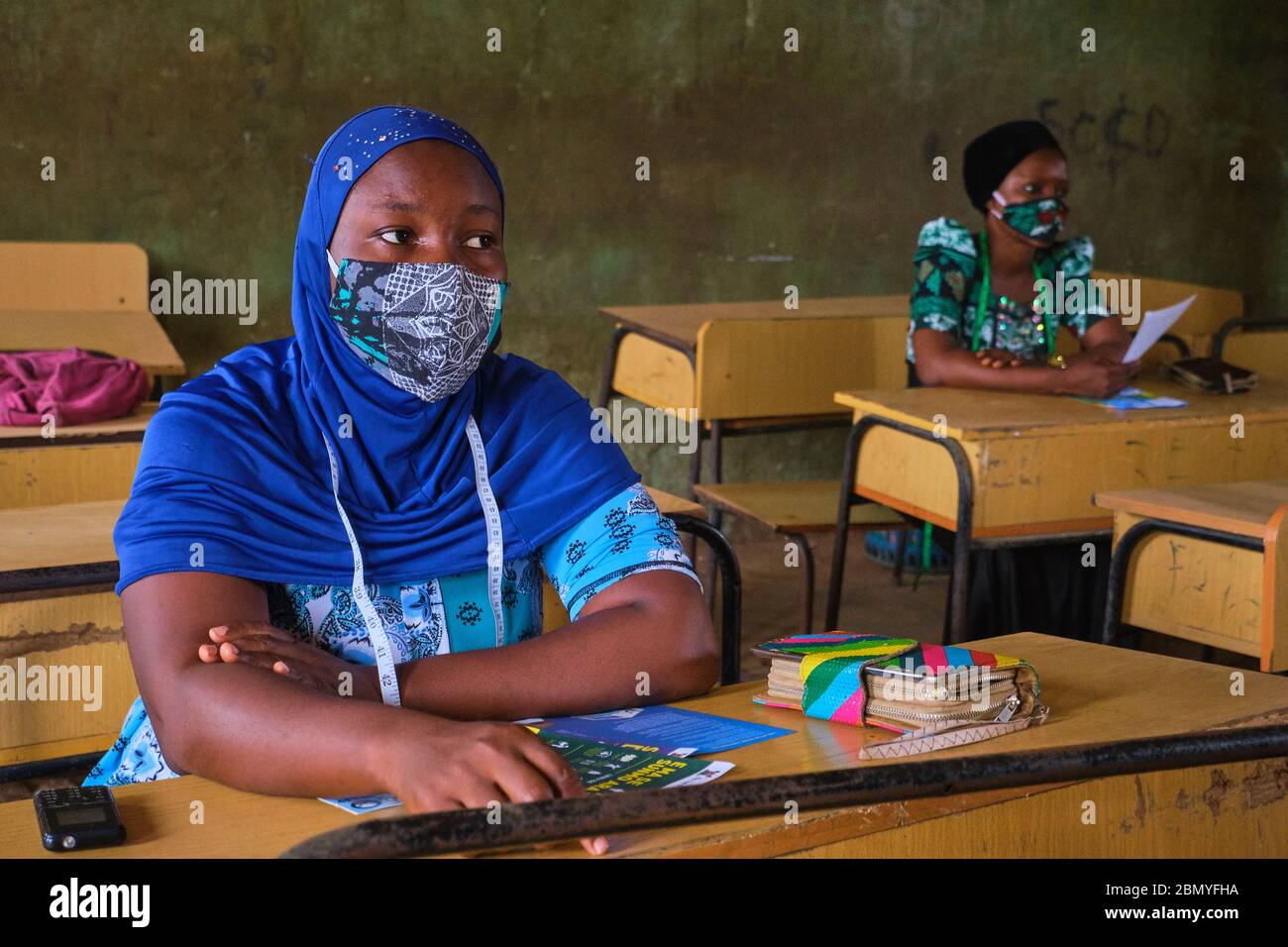 People donning face masks sit in a class during a Social Distancing ...