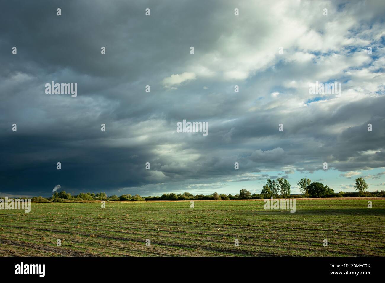 A dynamic rain cloud coming over the green sunny fields Stock Photo - Alamy