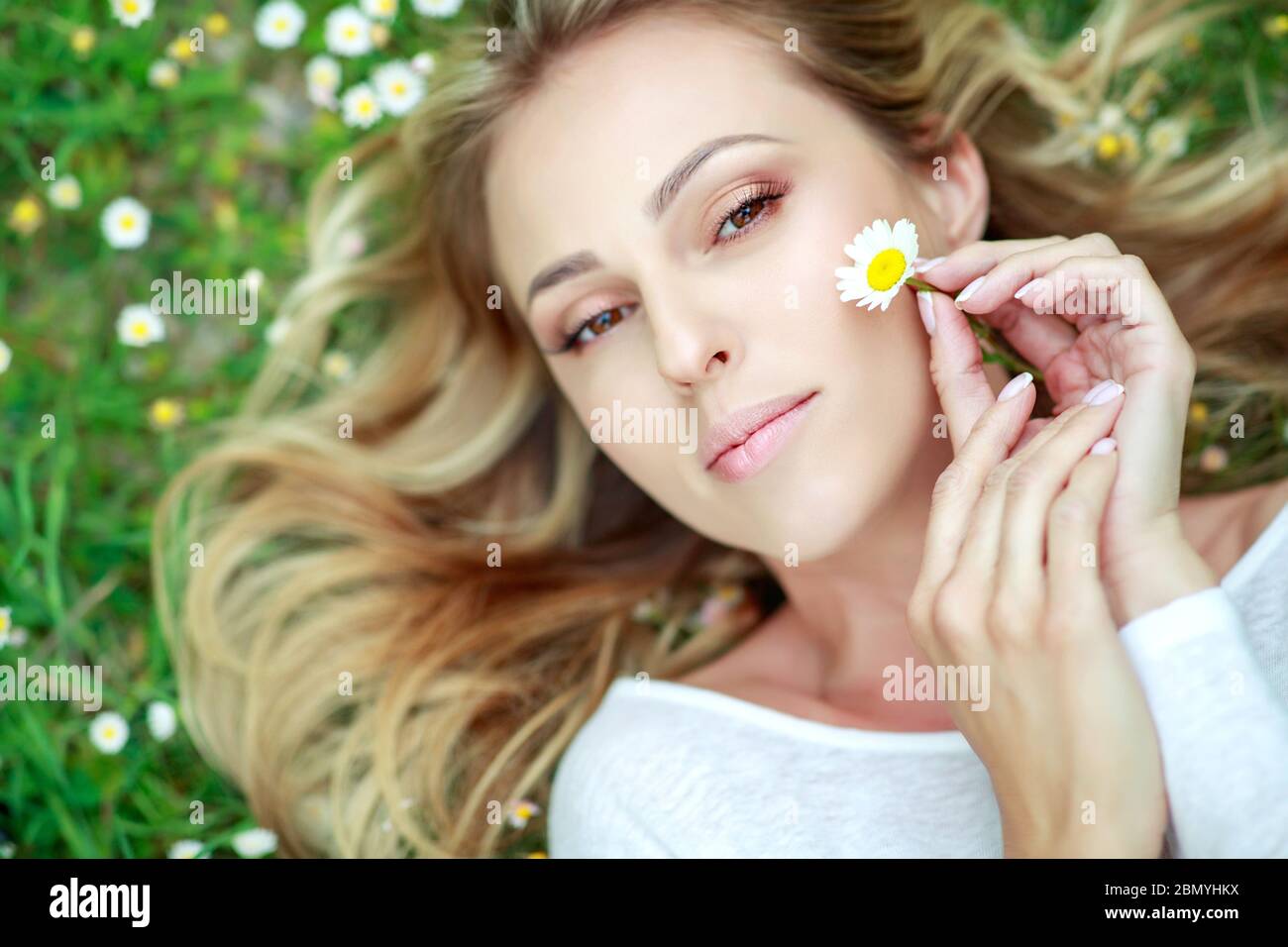 Beautiful woman with a flower Stock Photo - Alamy
