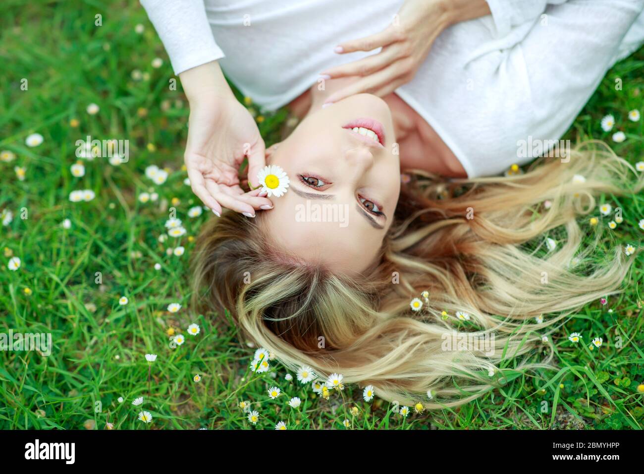 Beautiful woman with a flower Stock Photo - Alamy