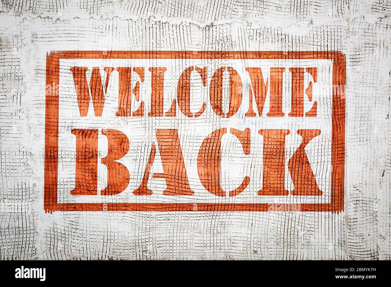 welcome back graffiti sign - red stencil text on a stucco wall ...